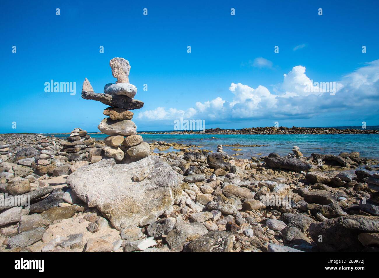 Stacked rocks balance on rocky beach in Aruba Stock Photo - Alamy