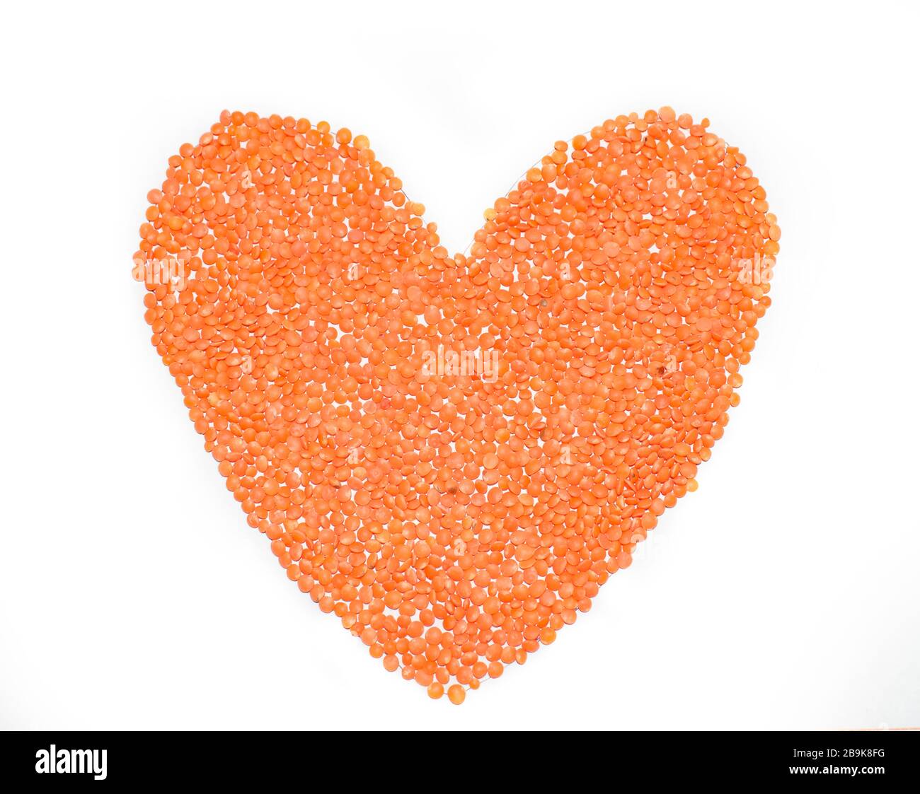 Love sign made with lentil in a white background Stock Photo - Alamy