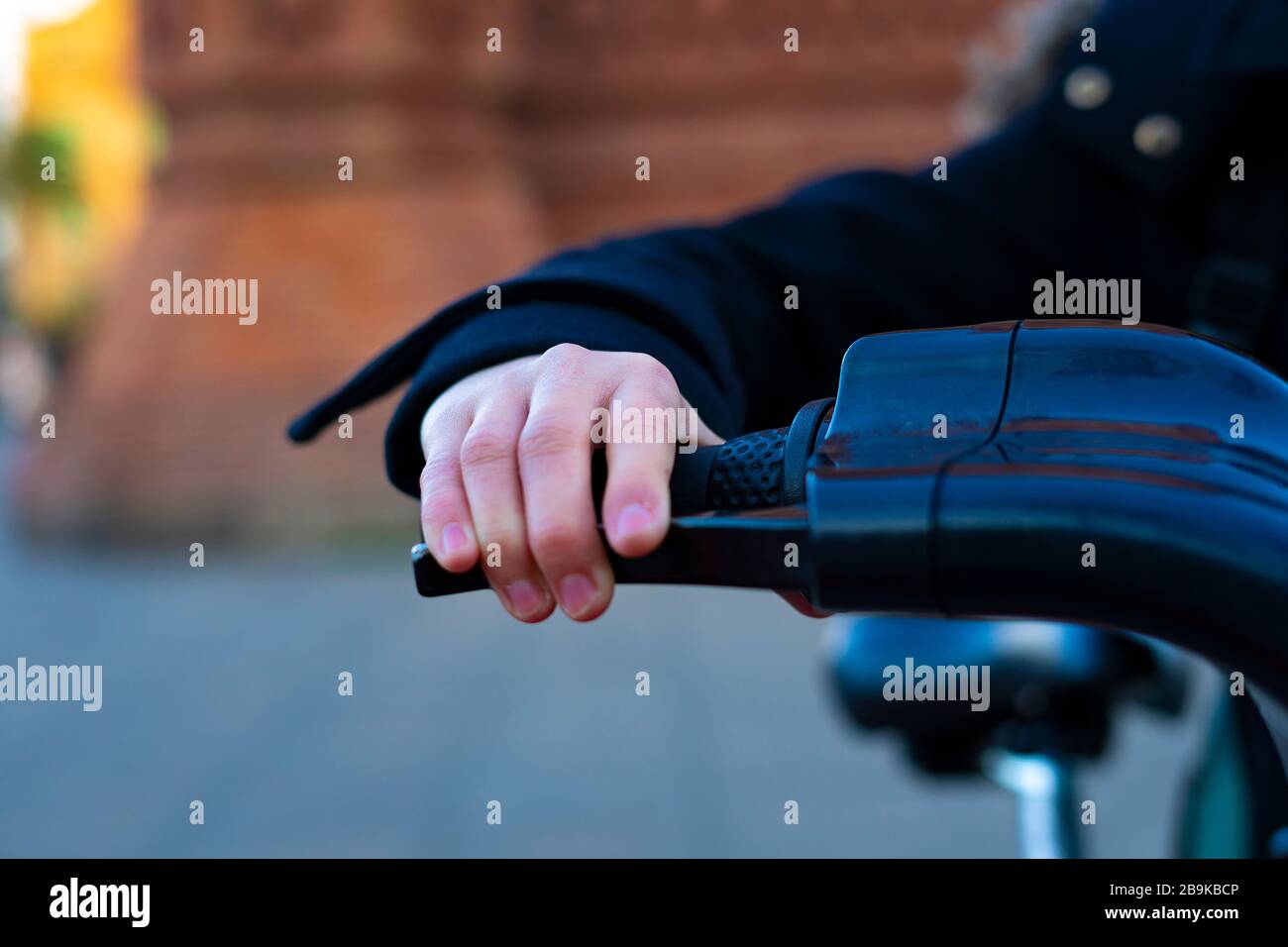 Hand taking the handlebars of a bicycle. Bike handles concept Stock ...