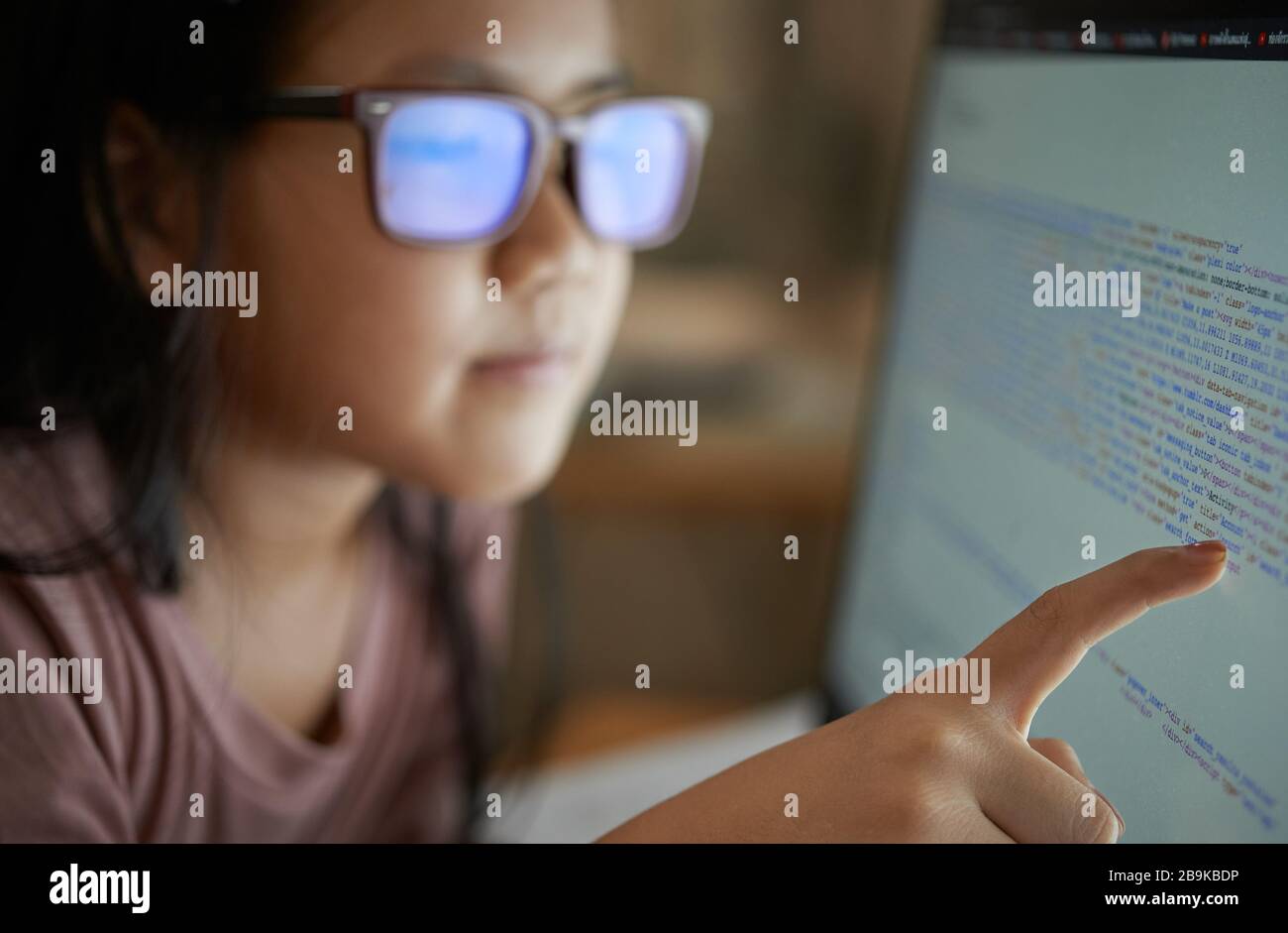 Close-up view of a girl reading code on the monitor Stock Photo - Alamy