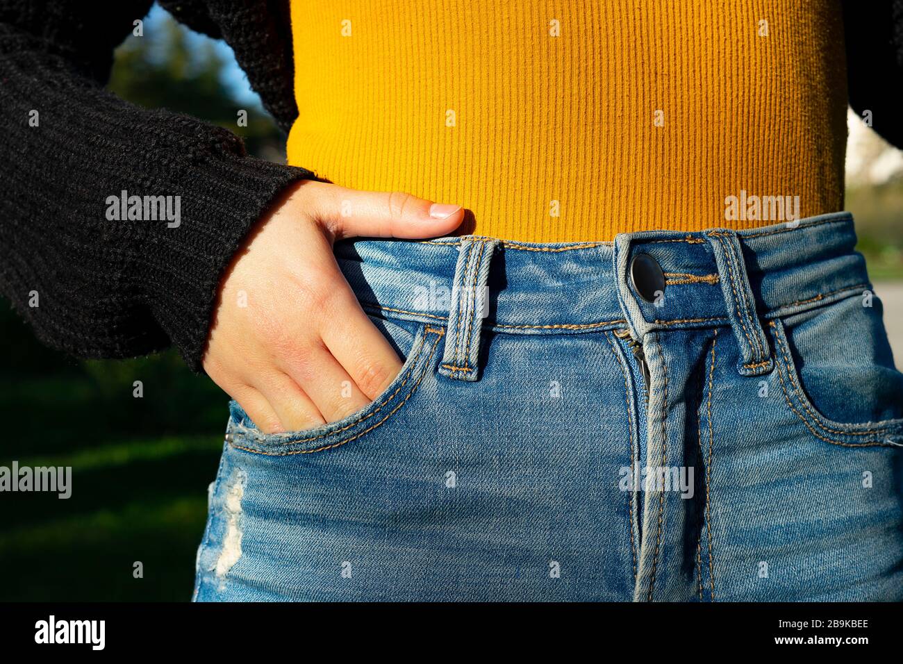 Woman putting her hands in her pocket. Concept of hand in pocket Stock ...