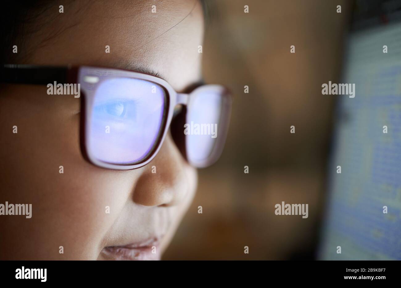 the face of a girl looking close to the monitor Stock Photo - Alamy