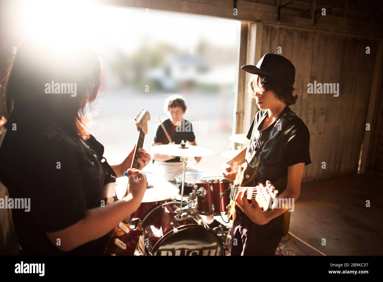 Three teenage boys playing instruments during band practice Stock Photo ...
