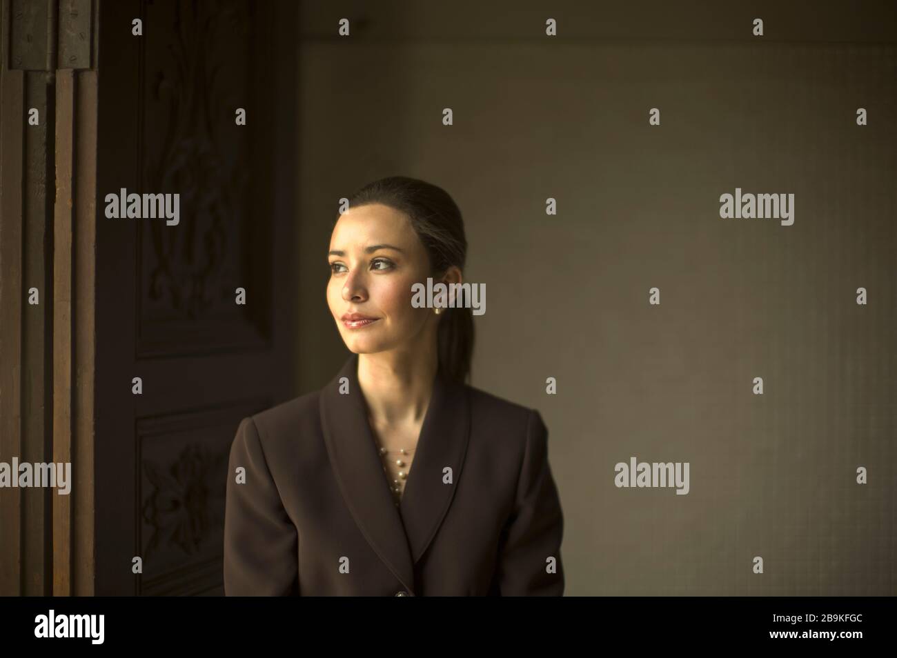 Solemn, elegant young woman poses for a portrait Stock Photo - Alamy