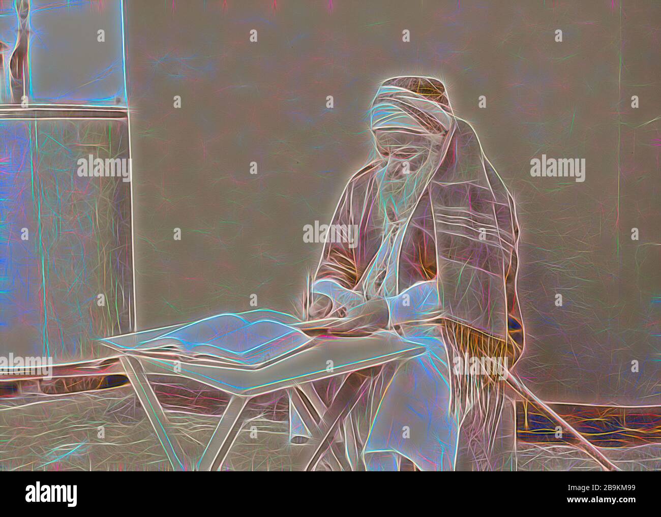 Abram with book in hand, writing. Photo shows Abram Ajwar, a Yemenite ...