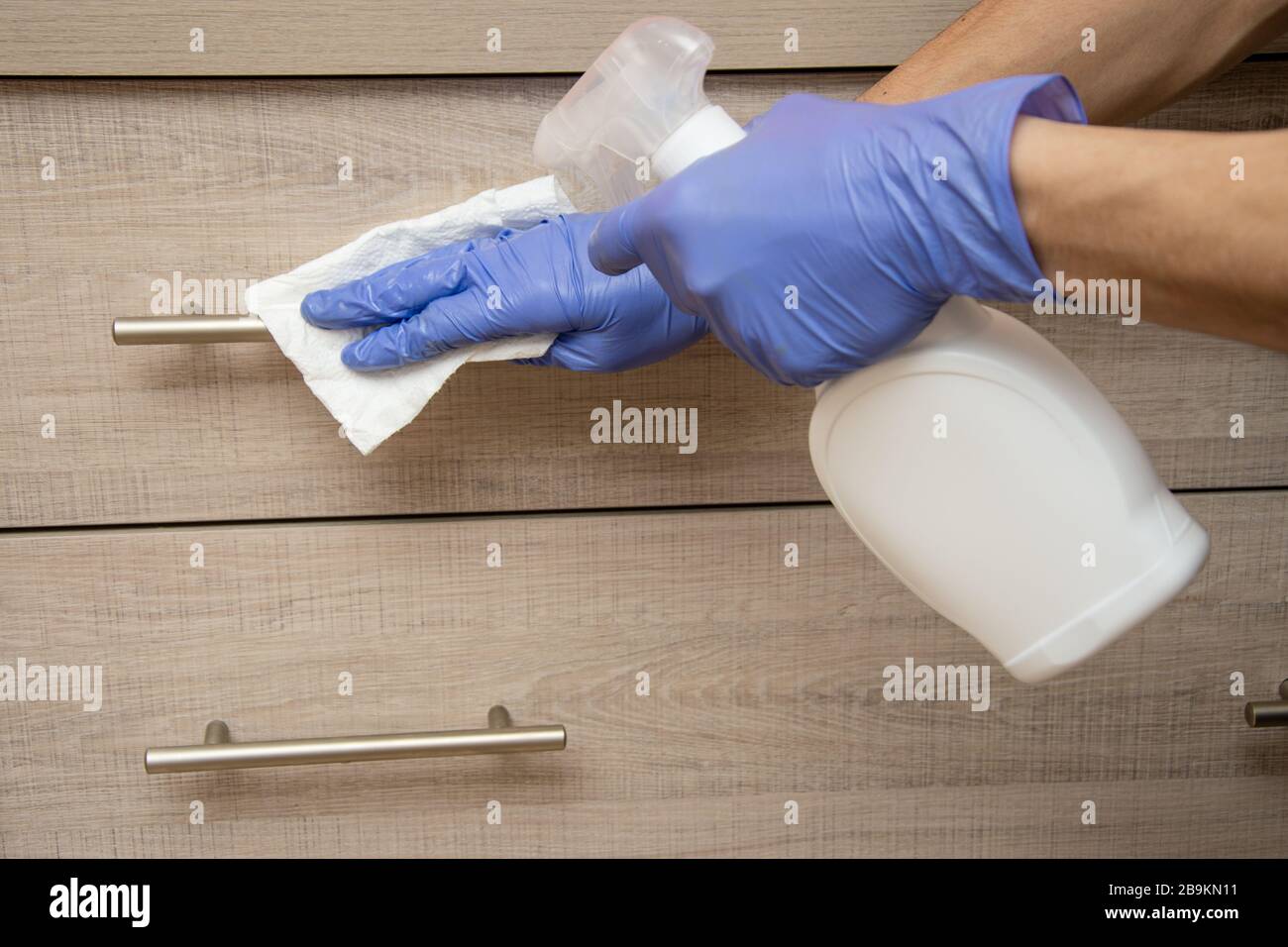 Disinfection and cleaning of cabinet handles. Prevention of coronavirus ...