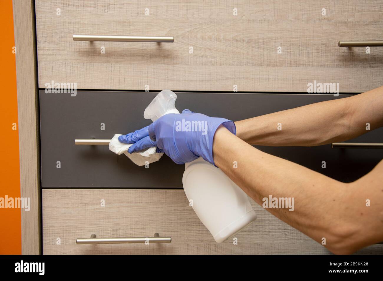 Disinfection and cleaning of cabinet handles. Prevention of coronavirus ...