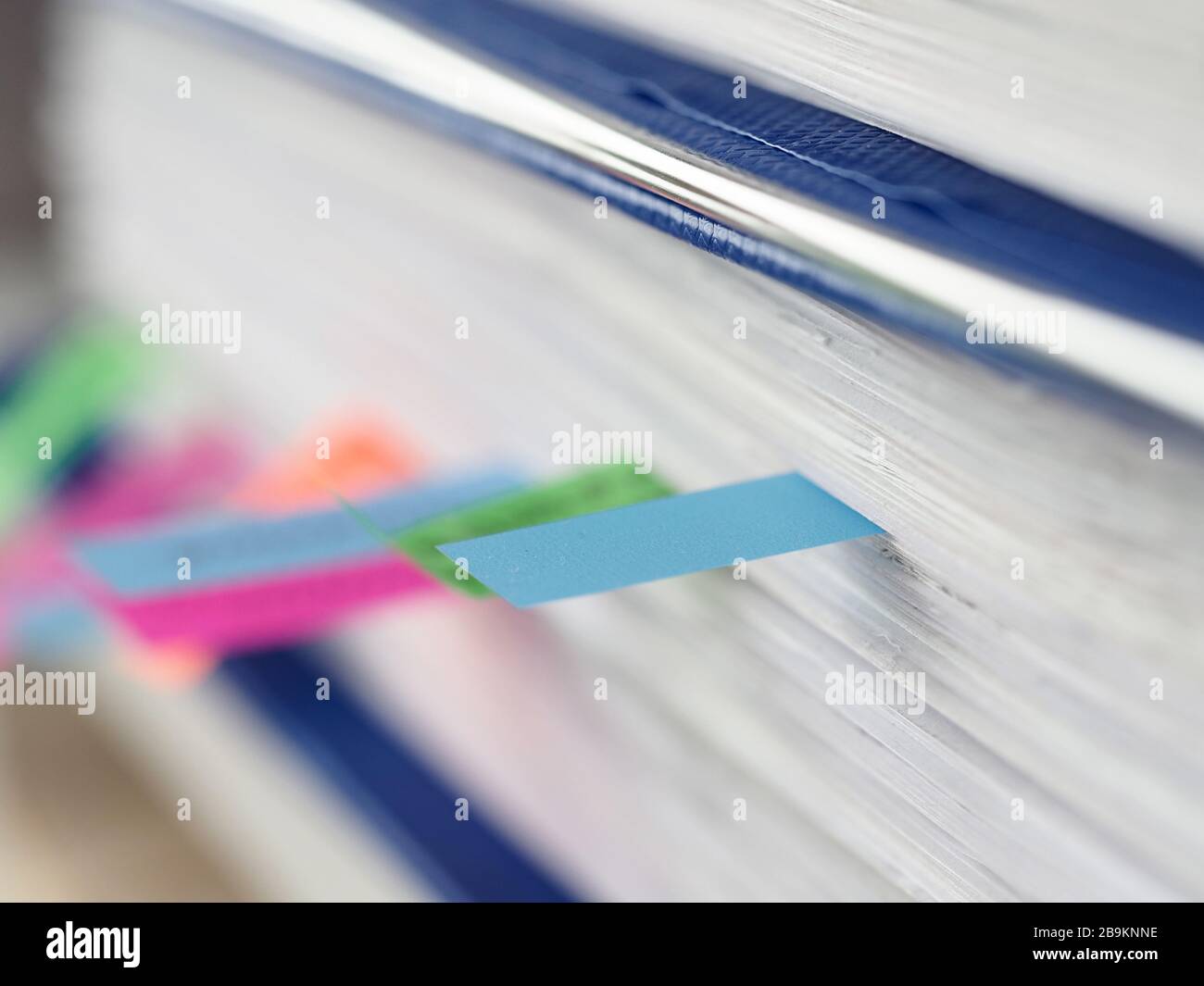Close up color stickers between documents folder Stock Photo - Alamy