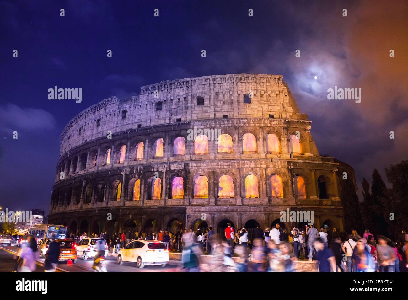 The Colosseum at night with a full moon in long exposure with trails ...