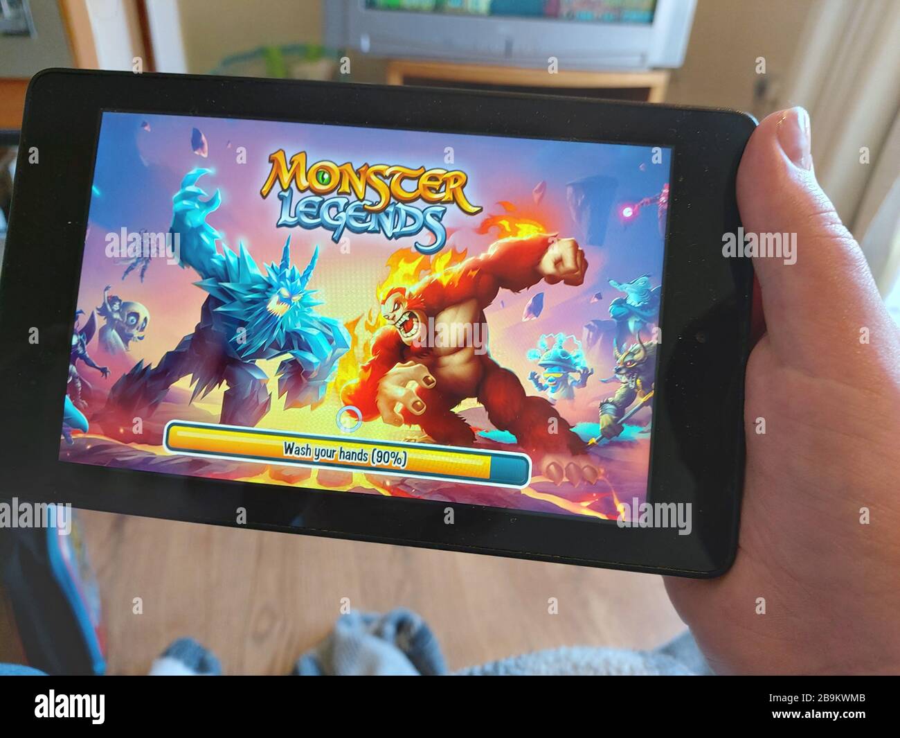 A video game on a tablet displays a public health message, reading ...