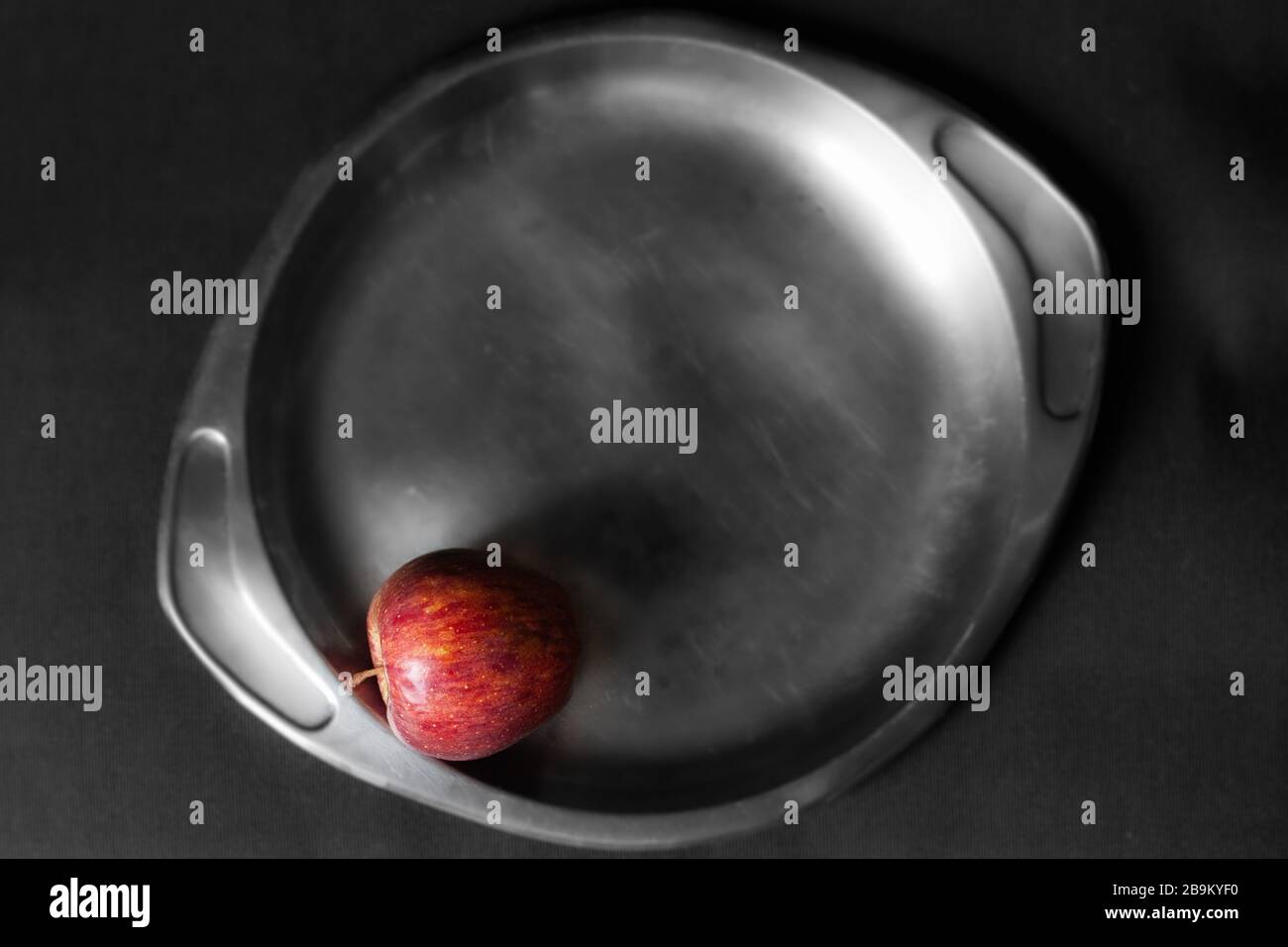 Red apple on old steel plate and black background. Top view ...