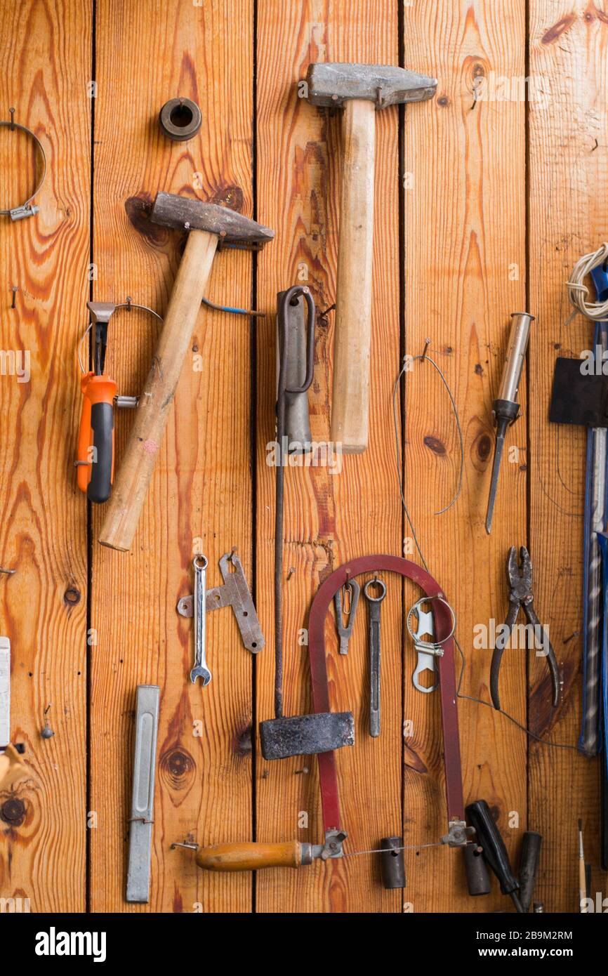 Carpentry tools hanging on the wooden wall Stock Photo - Alamy