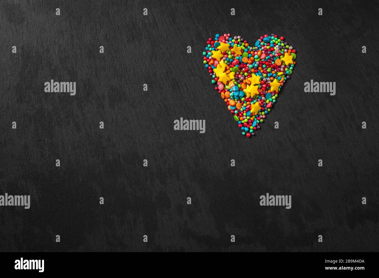 Sprinkle heart shape background. Sprinkle in the form of stripes, balls ...