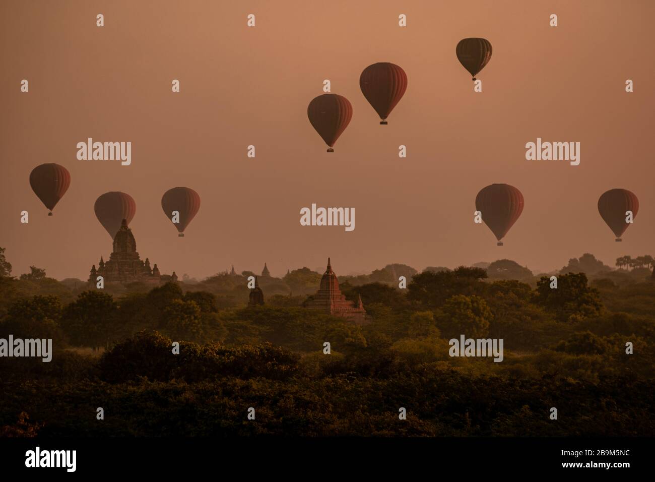 Bagan Myanmar, hot air balloon during Sunrise above temples and pagodas ...