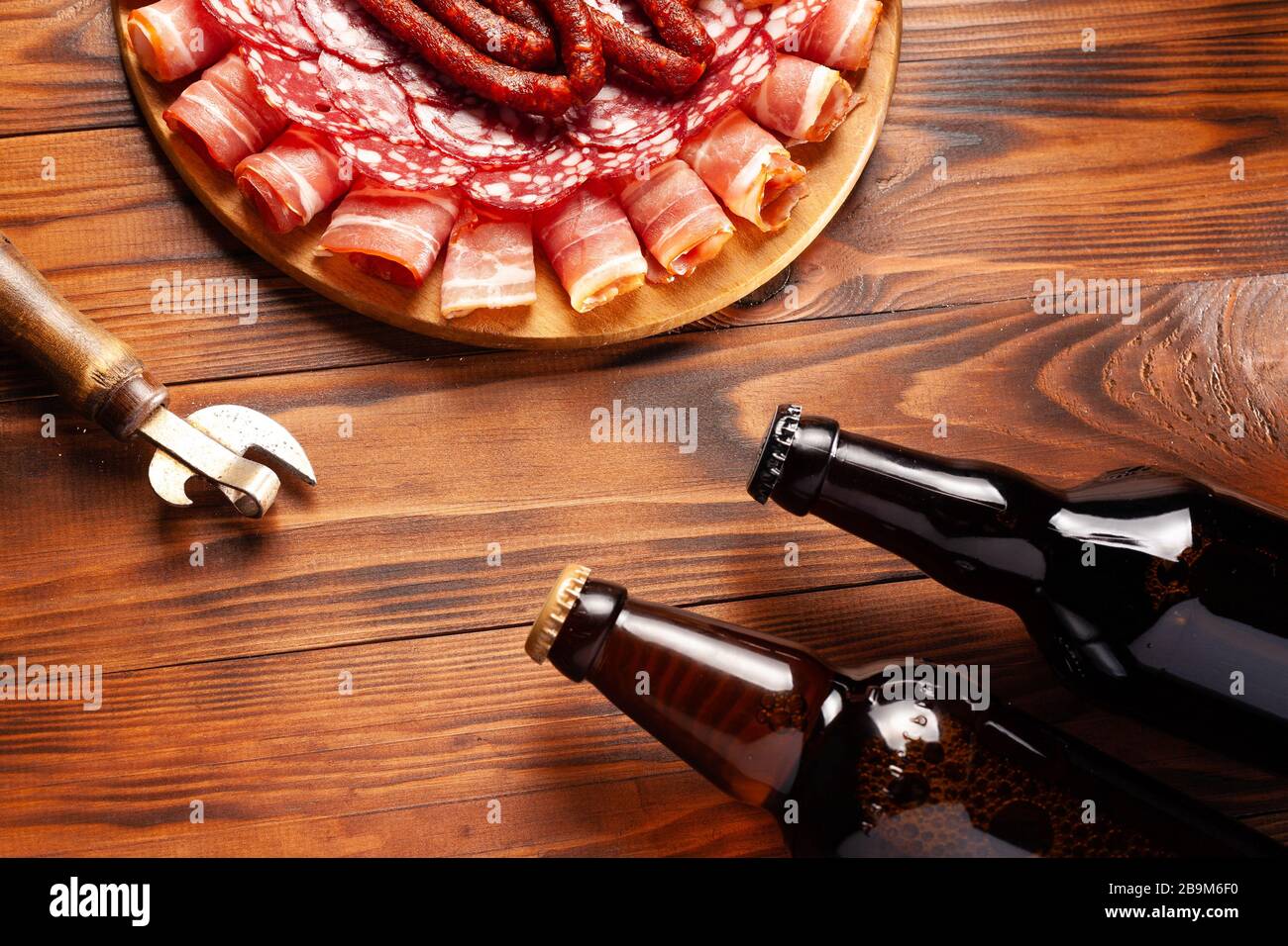 Beer snack in the form of meat products and bottled beer. Appetizer in ...