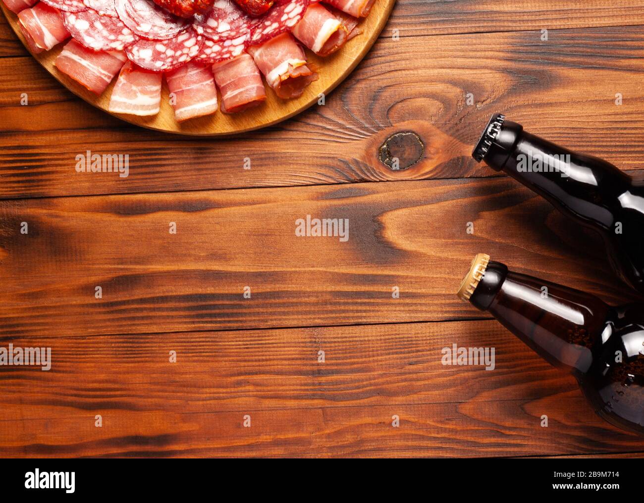 Beer snack in the form of meat products and bottled beer. Appetizer in ...