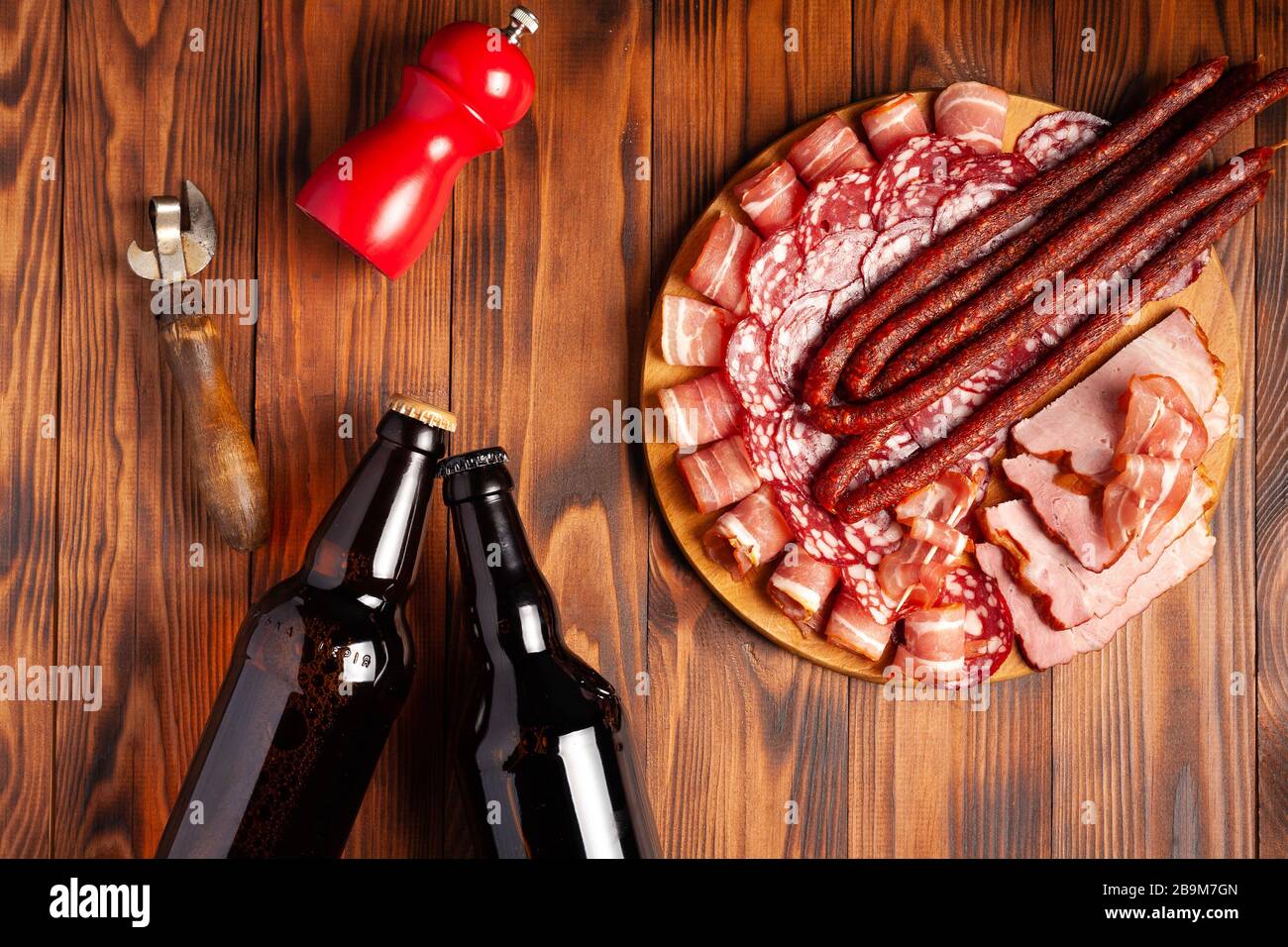 Beer snack in the form of meat products and bottled beer. Appetizer in ...