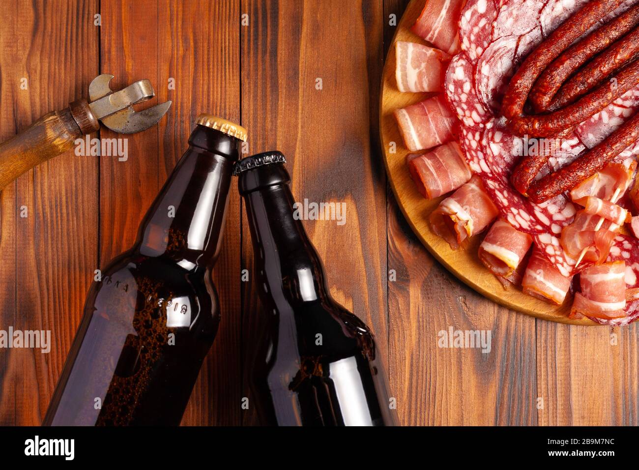 Beer snack in the form of meat products and bottled beer. Appetizer in ...