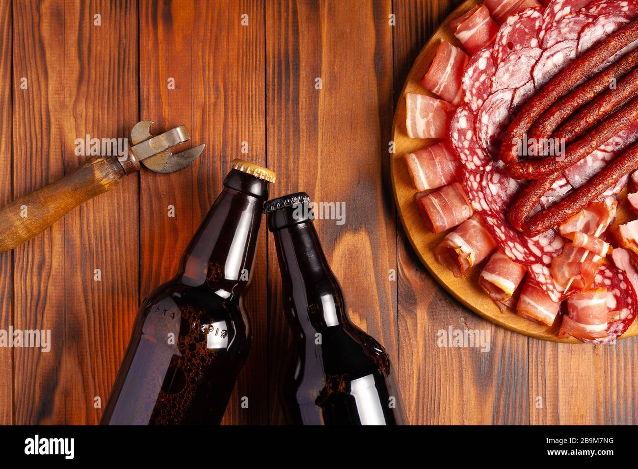 Beer snack in the form of meat products and bottled beer. Appetizer in ...