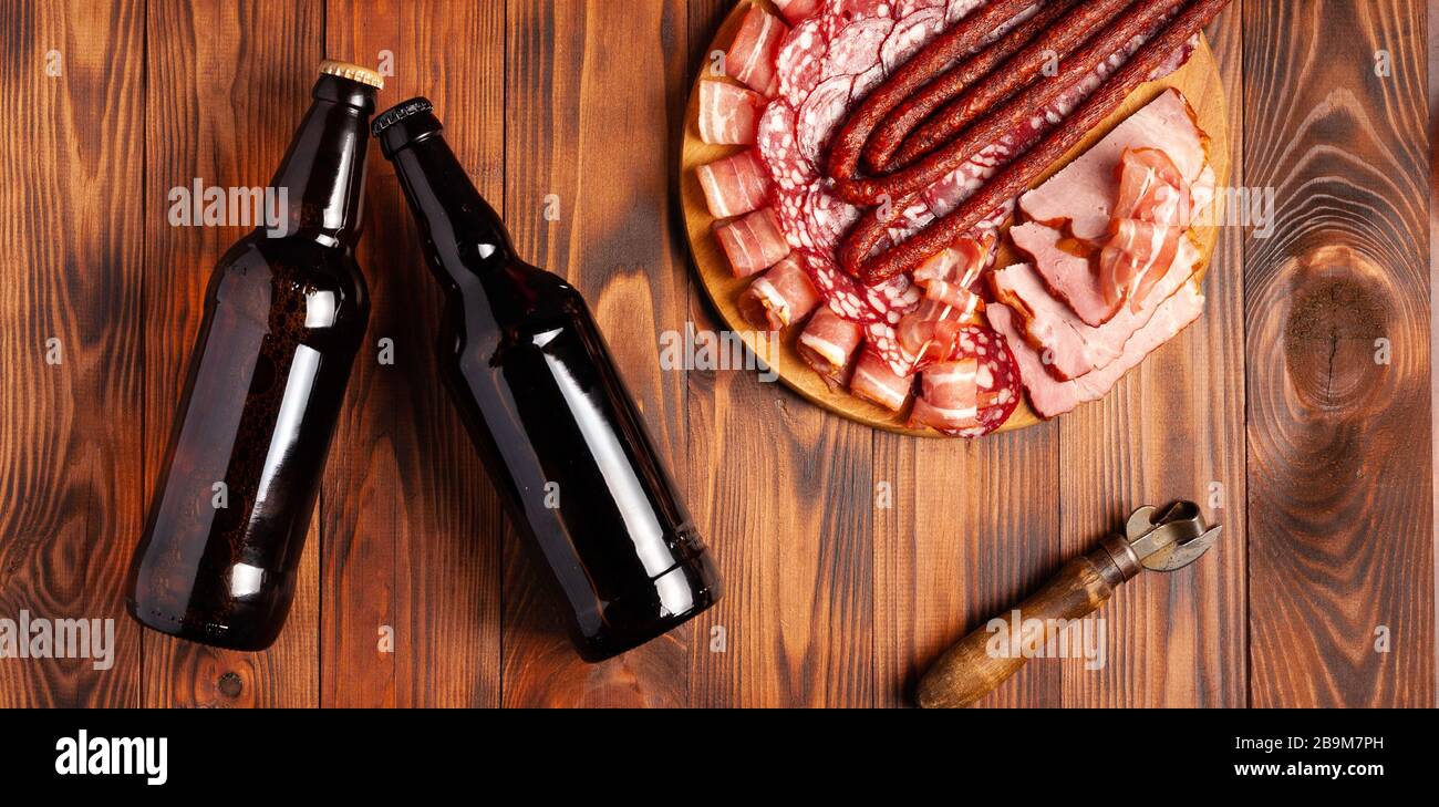 Beer snack in the form of meat products and bottled beer. Appetizer in ...