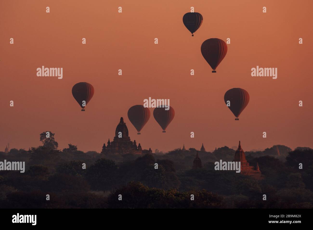 Bagan Myanmar, hot air balloon during Sunrise above temples and pagodas ...