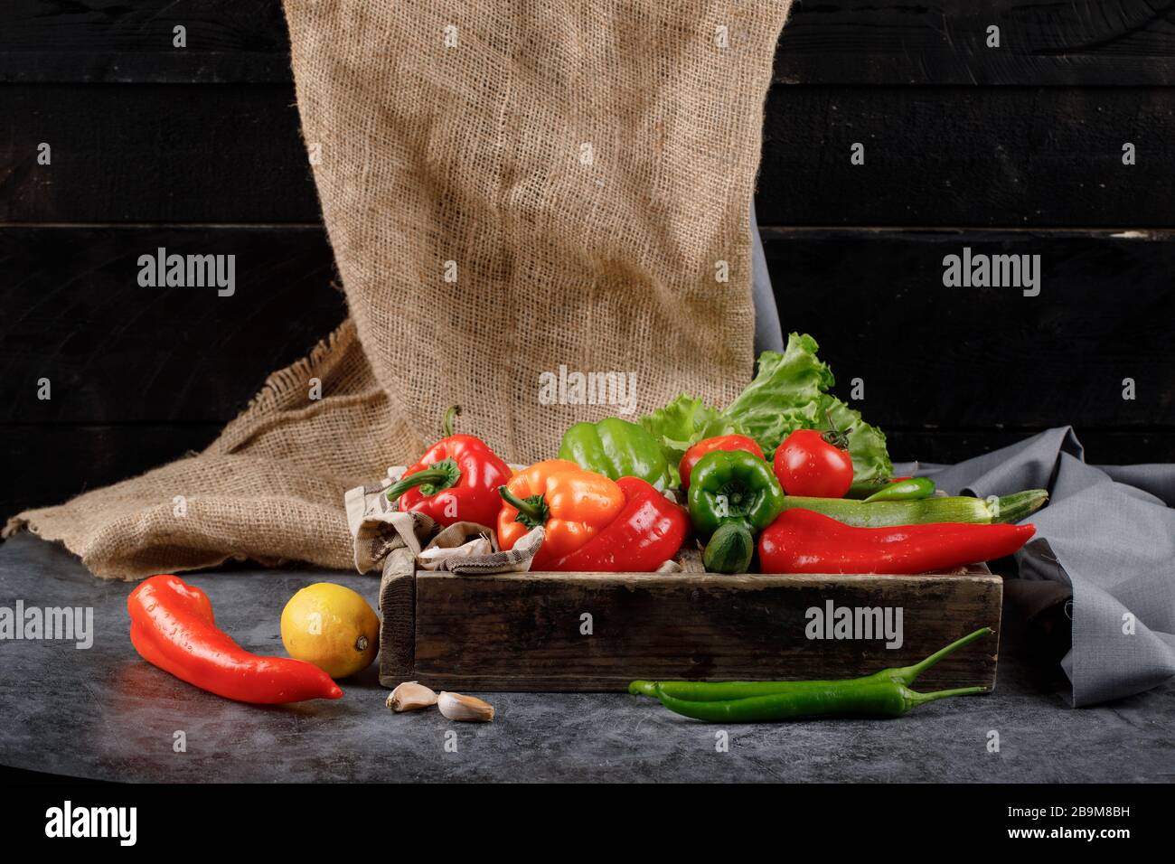 Mixed color bell peppers on a rustic background Stock Photo - Alamy