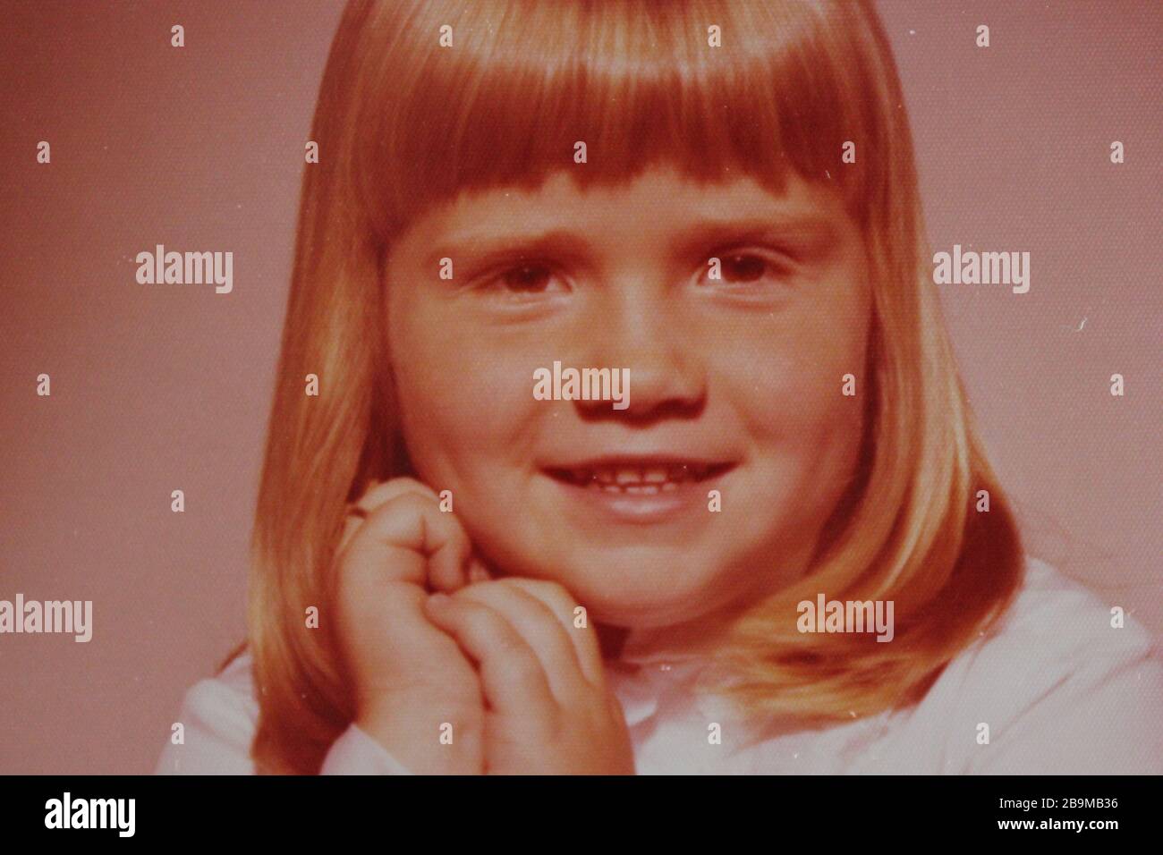 Formal grade school portrait of a beautiful young caucasian girl with ...