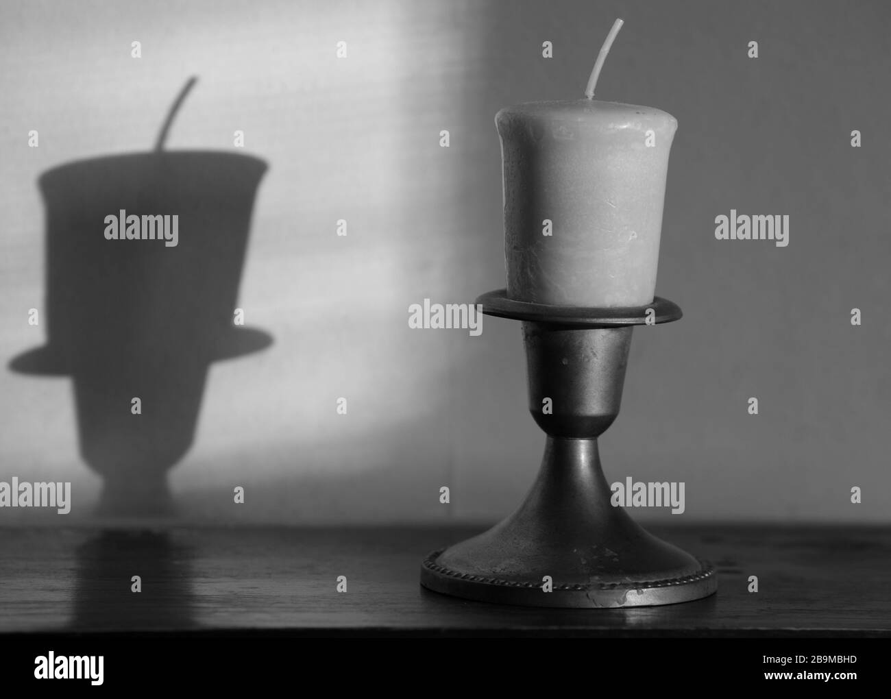 Black and white candle and its shadow Stock Photo - Alamy