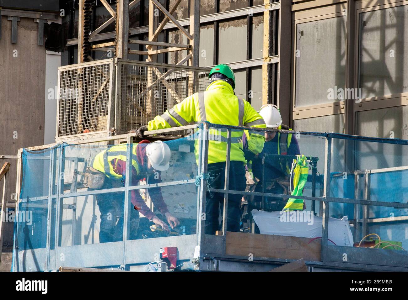 Constructions workers on a building site in Belfast Stock Photo - Alamy