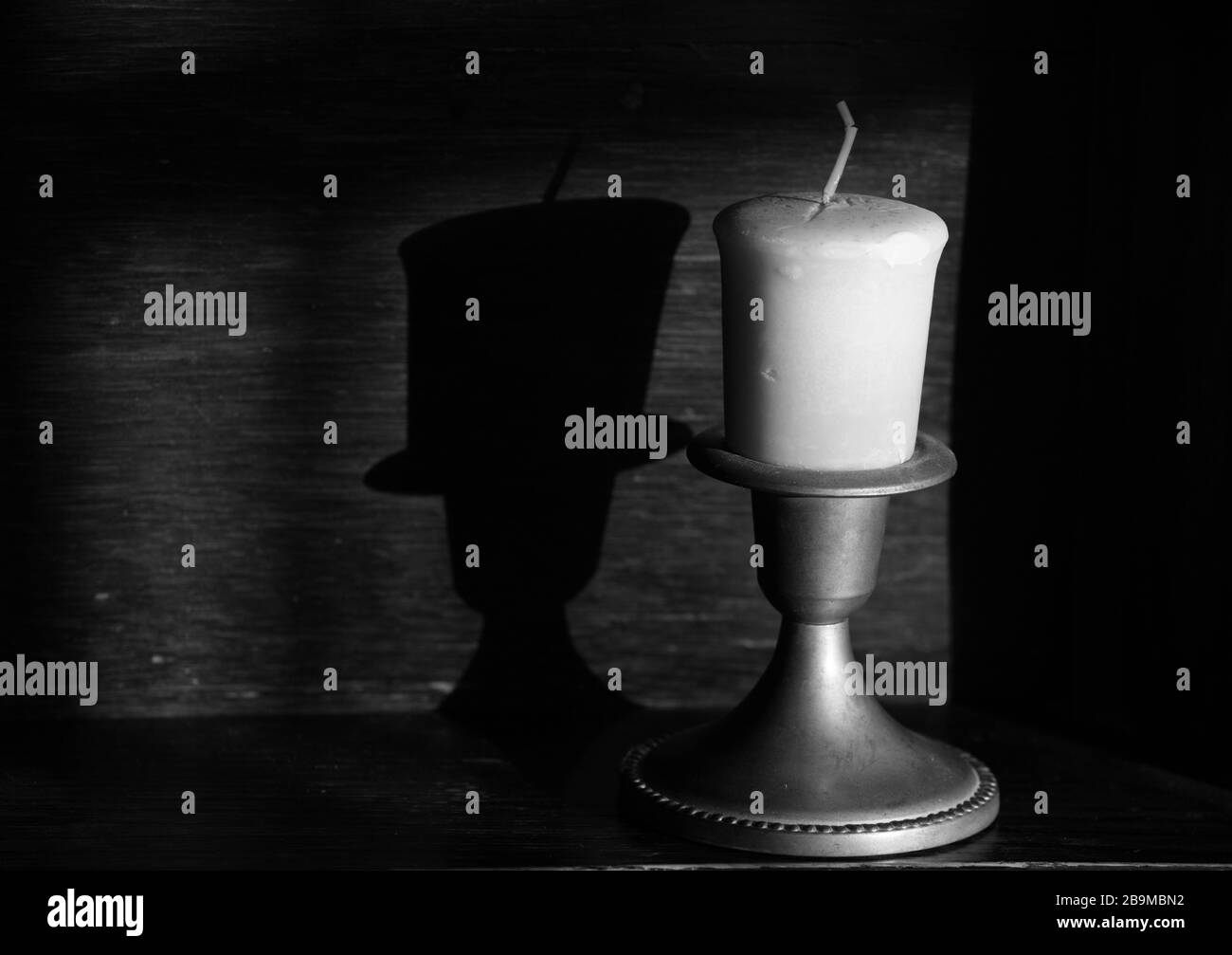 Black and white candle and its shadow Stock Photo - Alamy