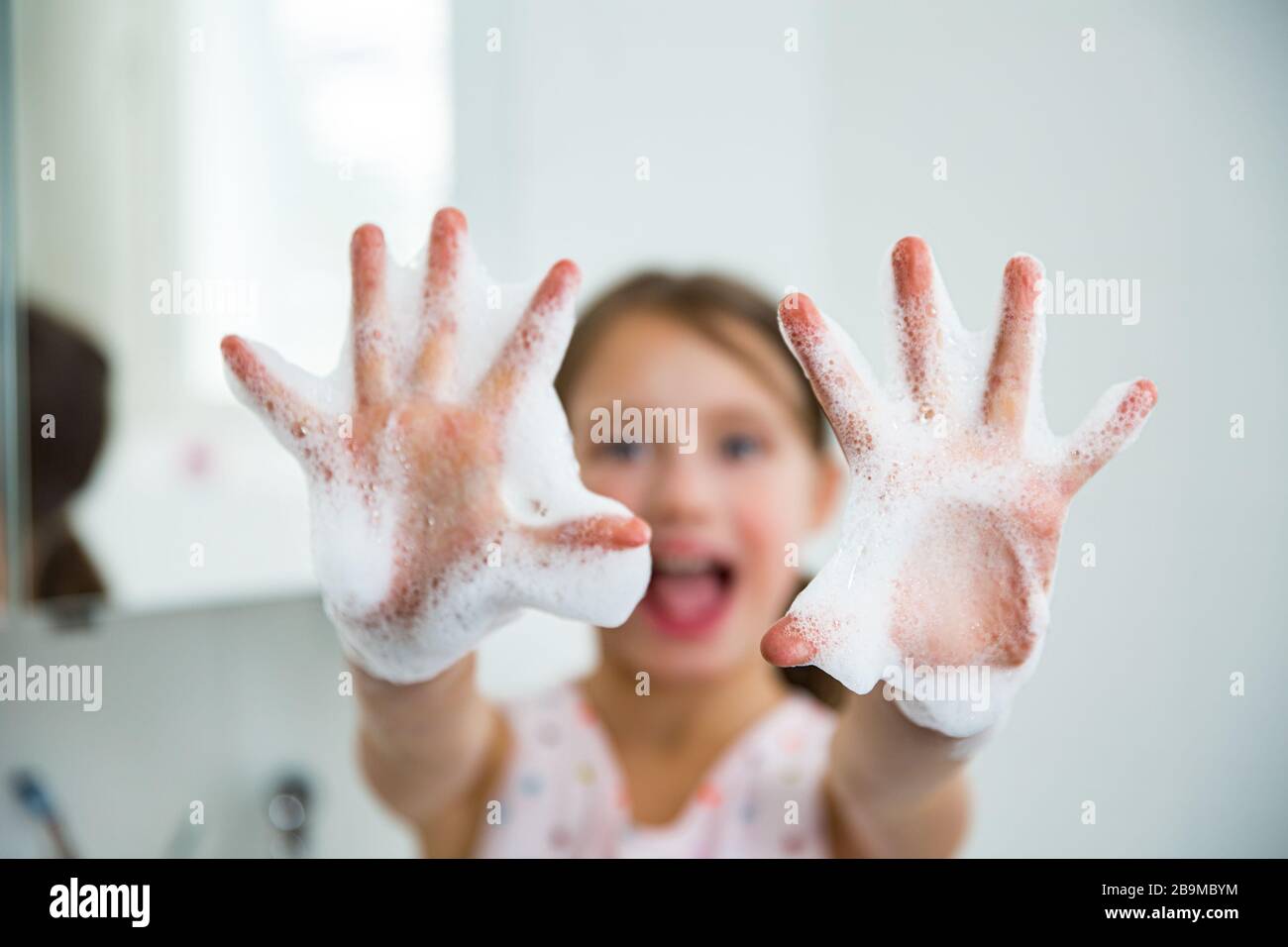Little girl washing hands with water and soap in bathroom. Hands ...