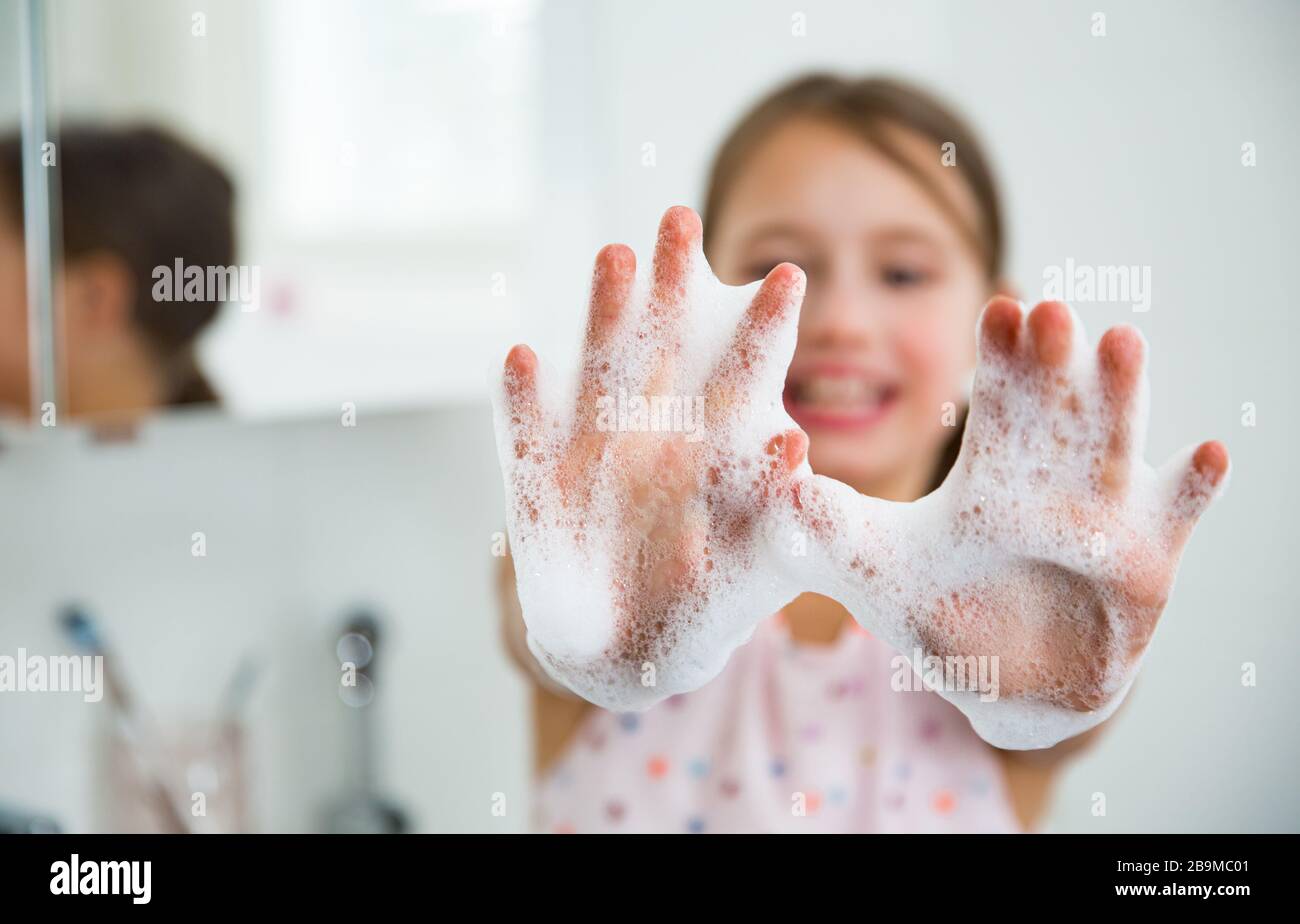 Little girl washing hands with water and soap in bathroom. Hands ...