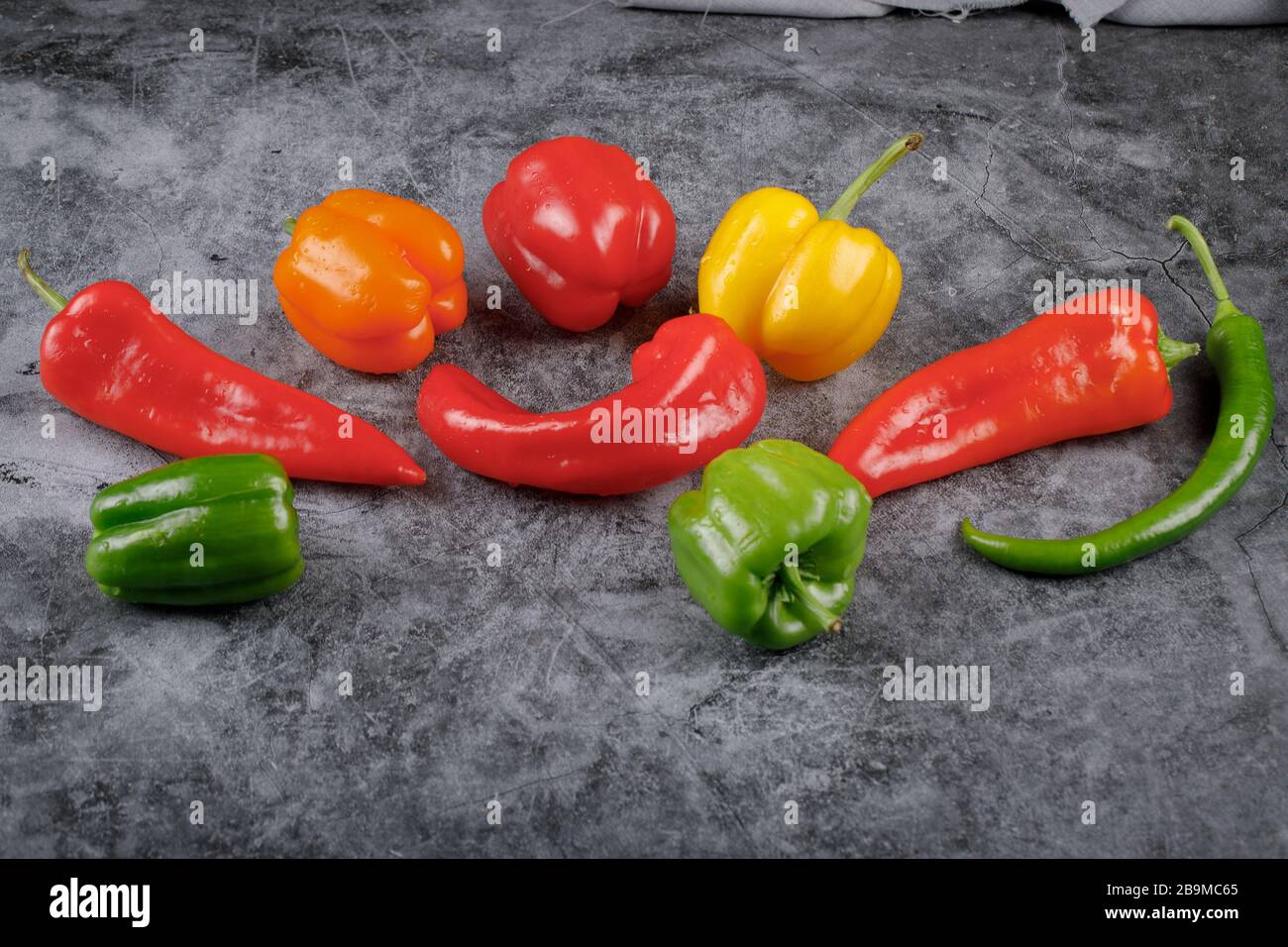 Colorful sweet and chili peppers on the grey marble Stock Photo - Alamy