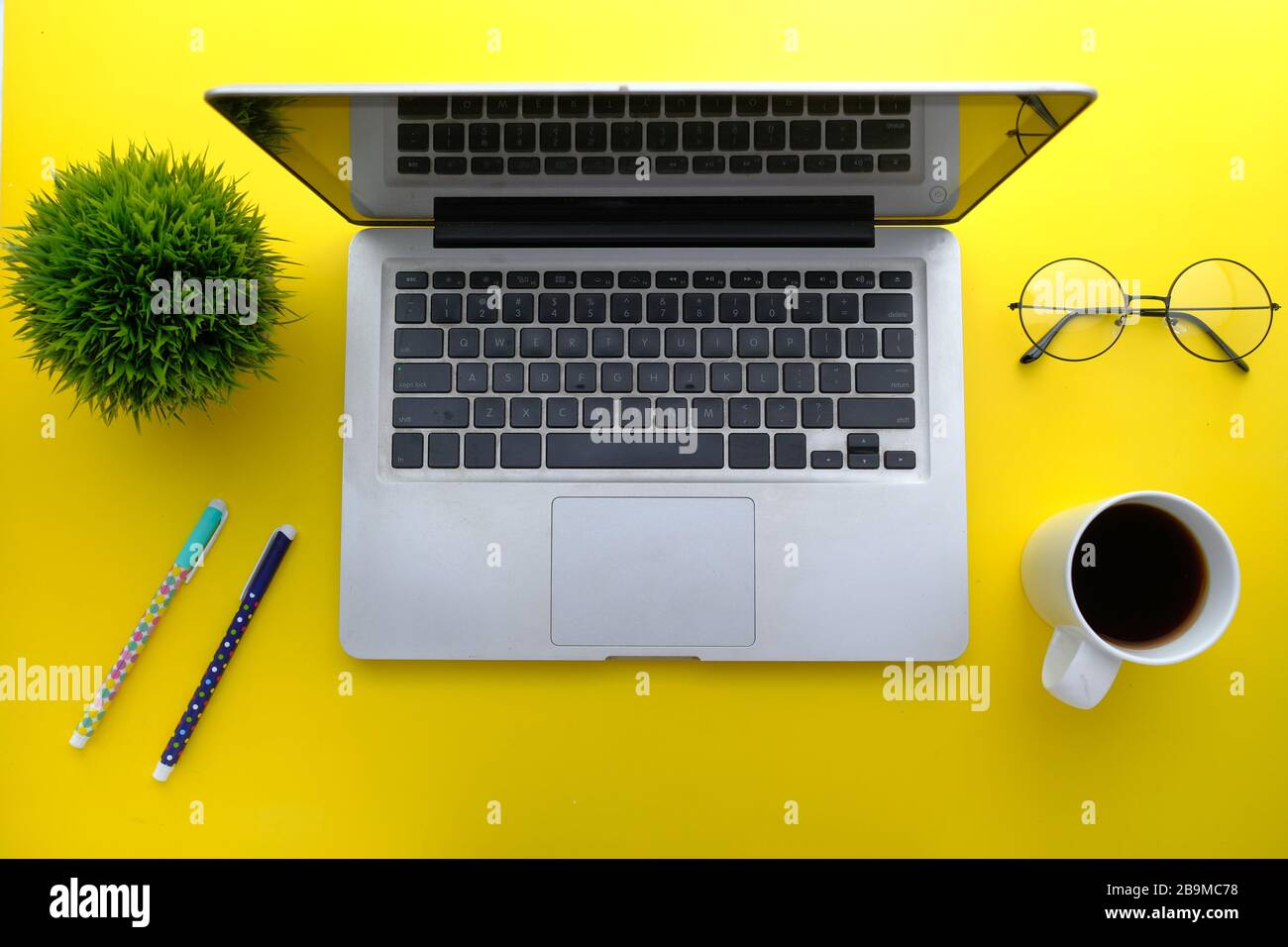 top view of laptop, tea and pen on yellow background Stock Photo - Alamy