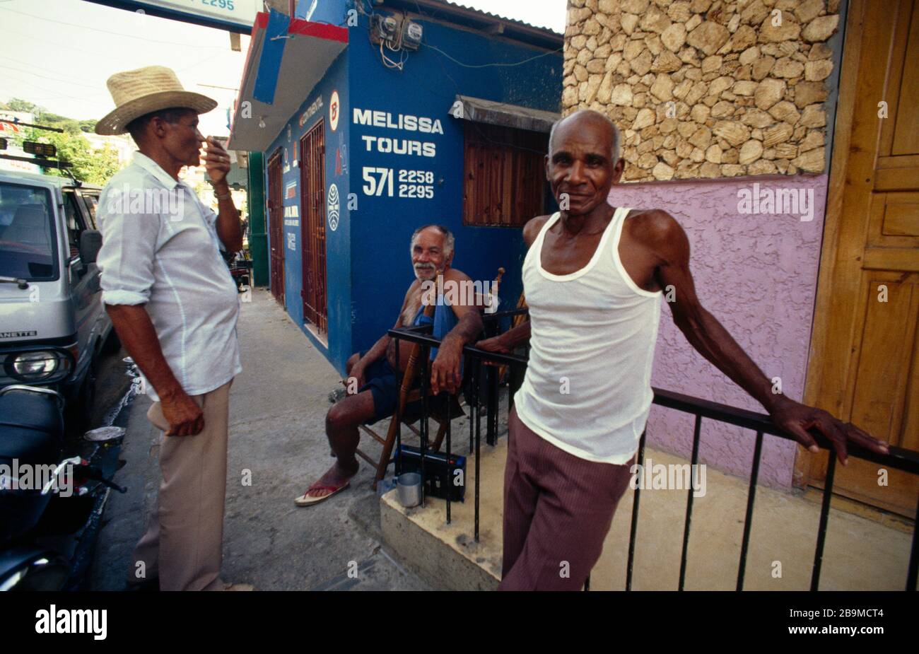 Dominican Republic Los Charamicos Men in Street Listening to Ghetto ...
