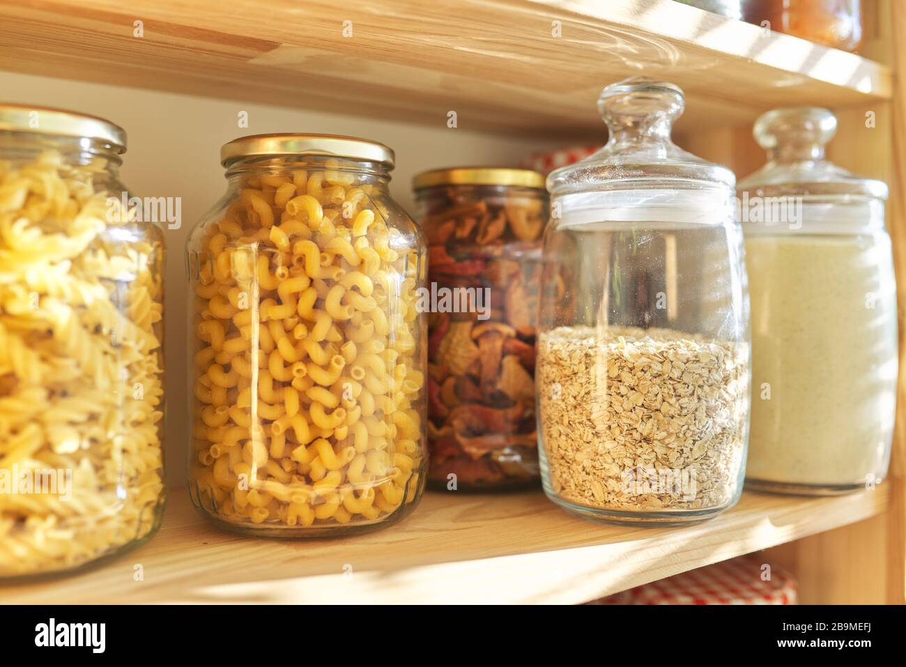 Wooden shelves in pantry for food storage, grain products in storage ...