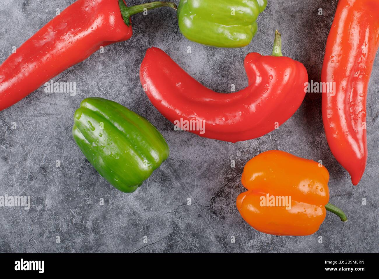 Different colors and kinds of hot chili peppers. Top view Stock Photo ...
