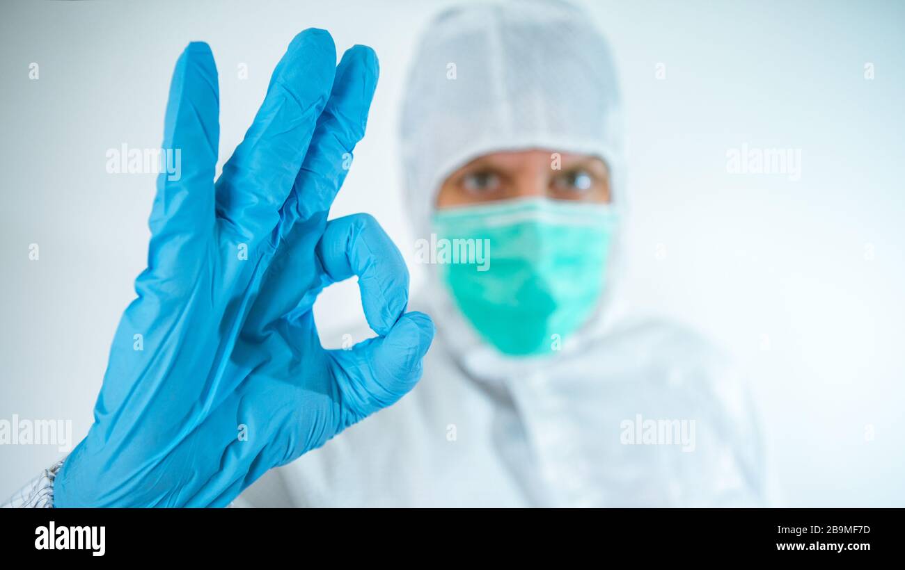 Male doctor hand pointing. A caucasian man in a protective suit and ...
