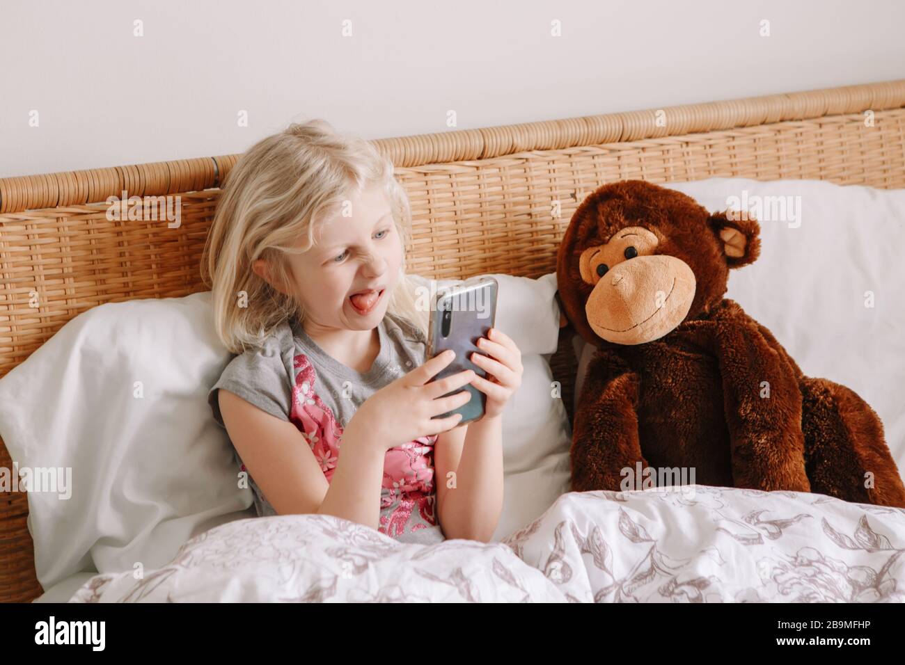 Cute adorable Caucasian girl stay at home and call her friends on ...