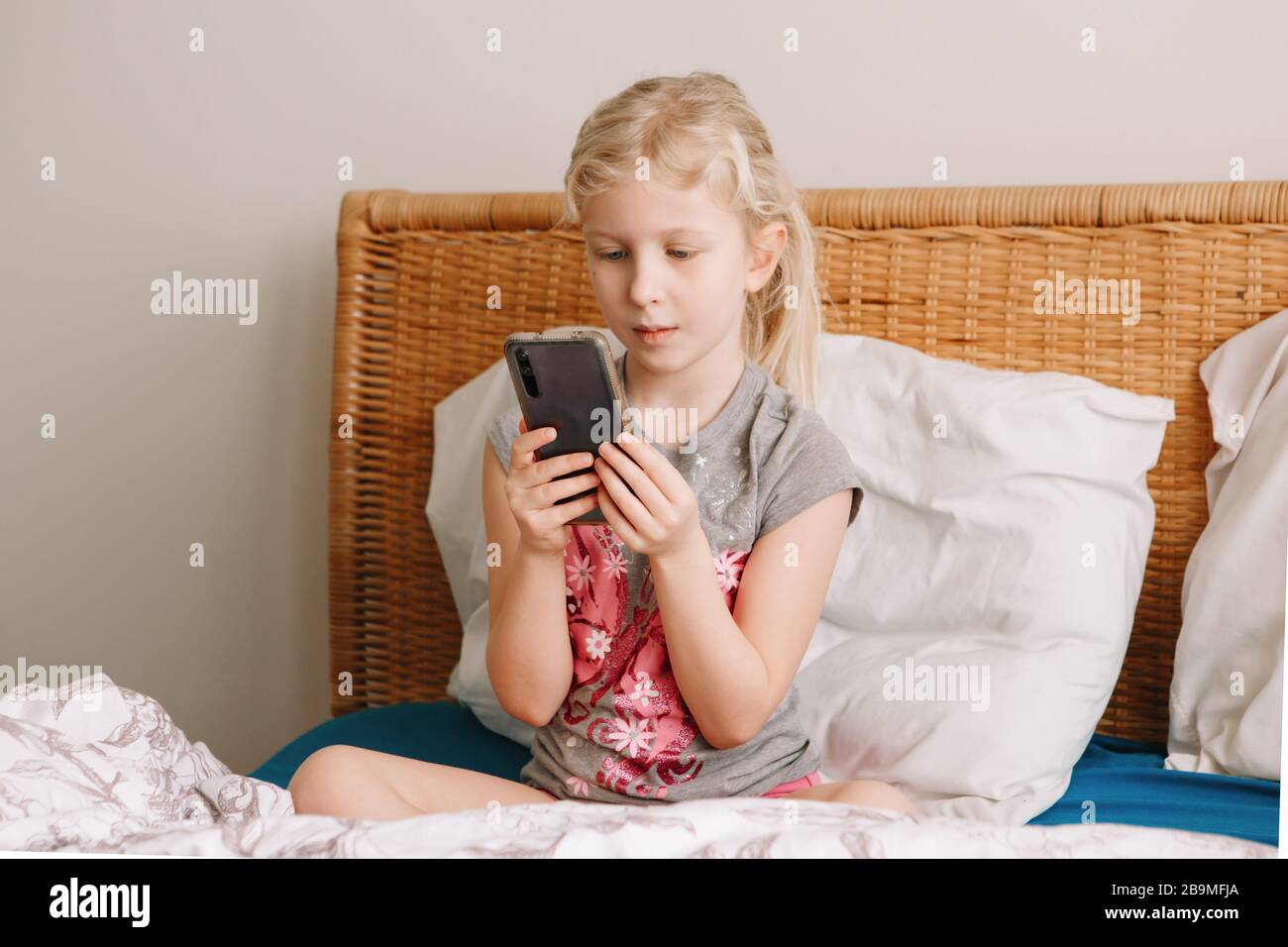 Cute adorable Caucasian girl stay at home and call her friends on ...