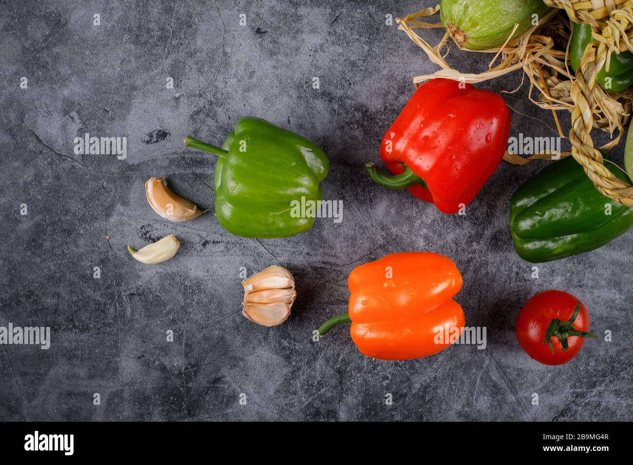 Colorful chili peppers and garlics on a blue stone Stock Photo - Alamy
