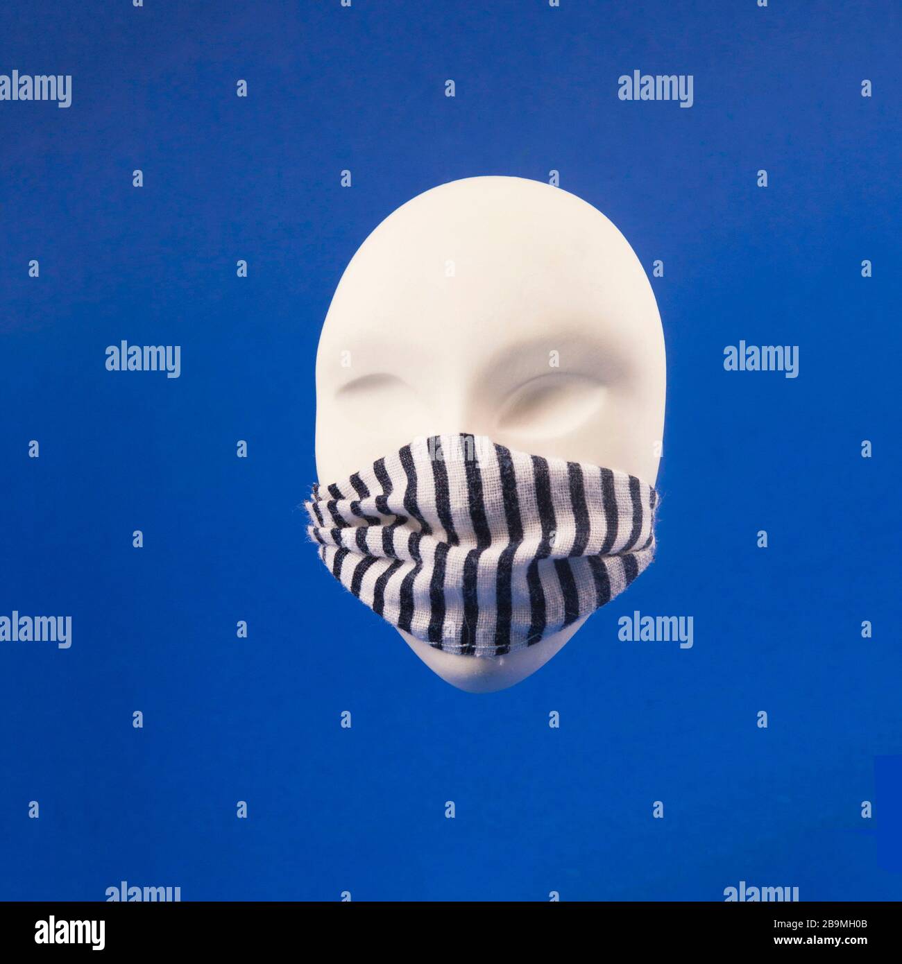 Gypsum female face in a medical protective mask against viruses ...