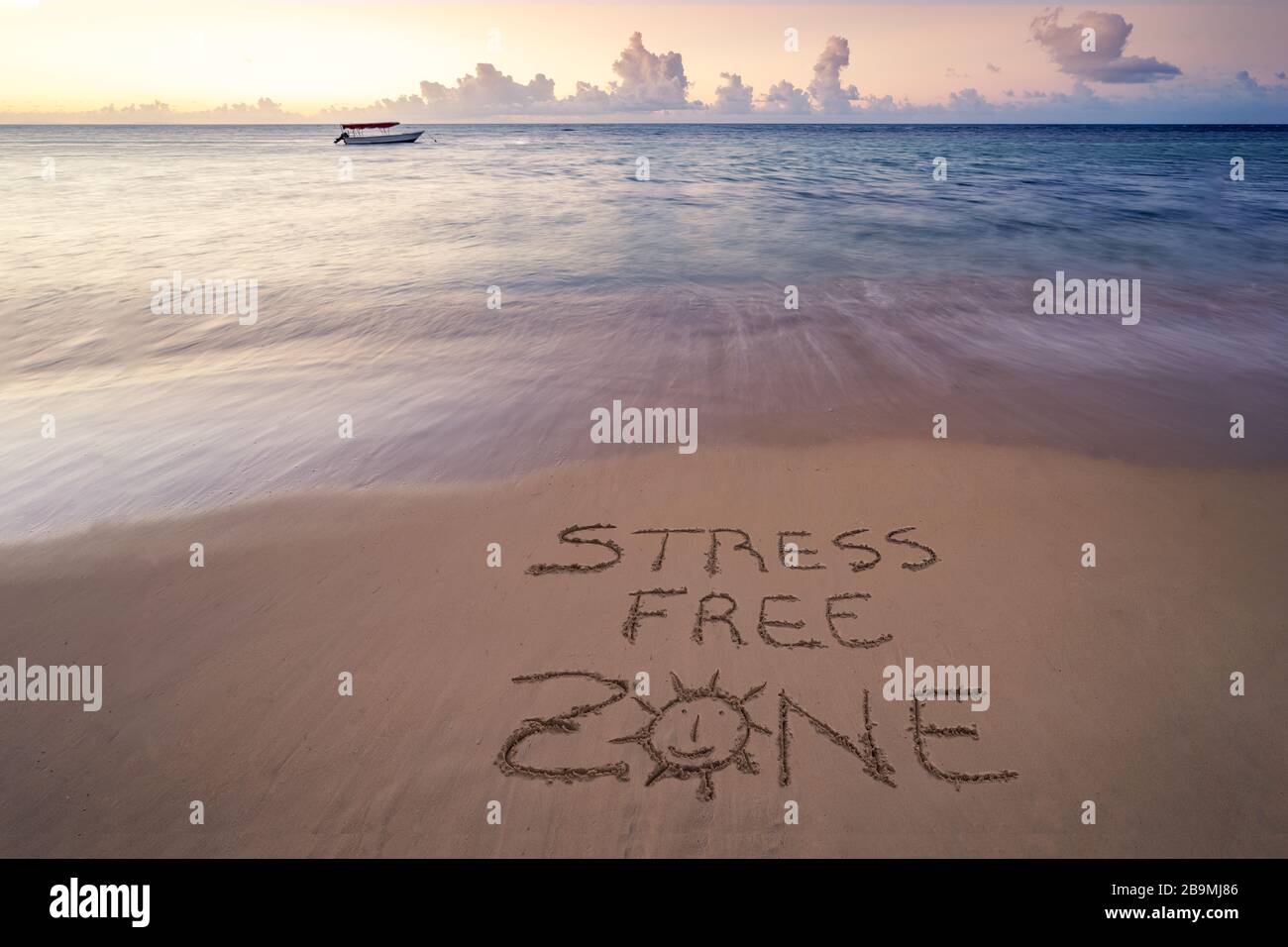 Handwritten Stress free zone on sandy beach at sunset,relax and summer ...