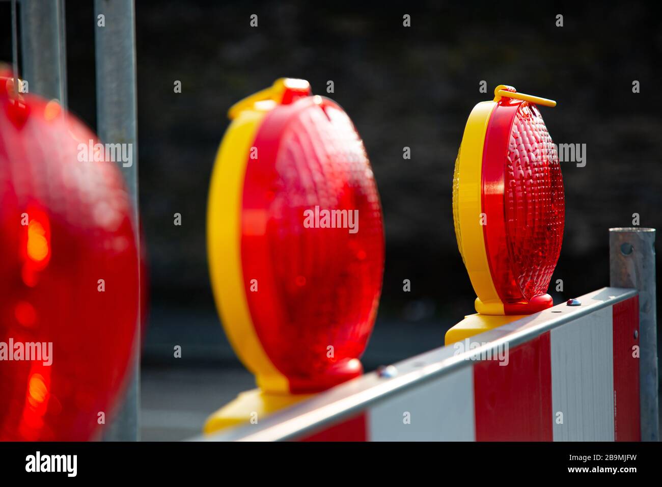Close-up of red warning lights with street barriers at a construction ...