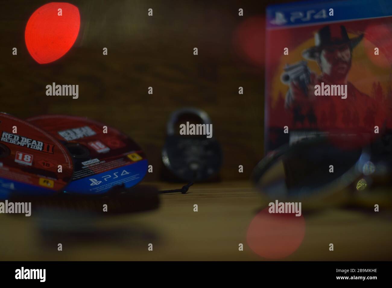 Red dead redemption 2 ps4 disc in beautiful setup with red bokeh Stock ...