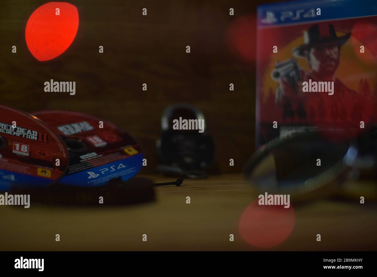 Red dead redemption 2 ps4 disc in beautiful setup with red bokeh Stock ...