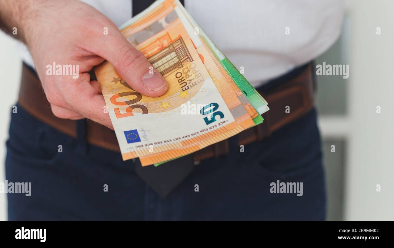 Male hands holding euro hi-res stock photography and images - Alamy