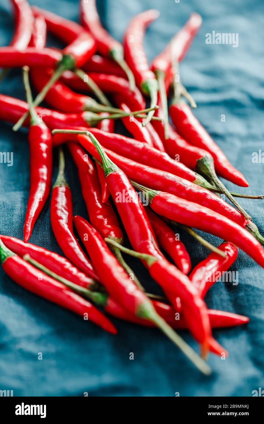 Macro photography of chili peppers on a blue linen Stock Photo - Alamy