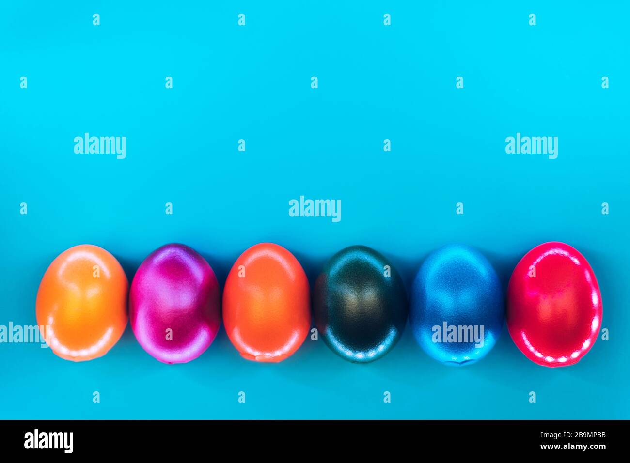 Glossy colorful eggs in neon trendy colors with creative backlight on ...