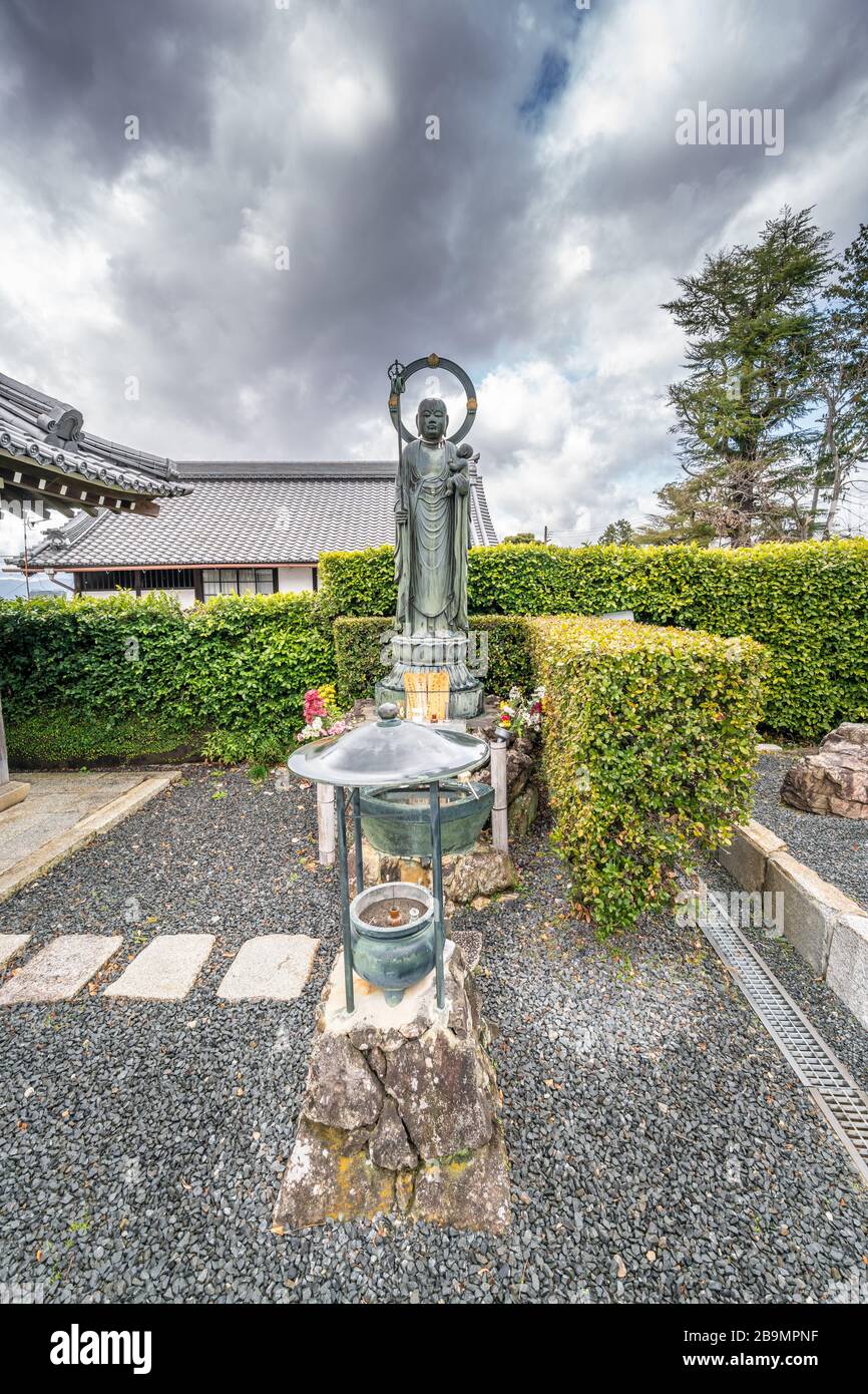Kyoto, Japan - March 11, 2019 Jokoro incense burner and Buddha statue ...